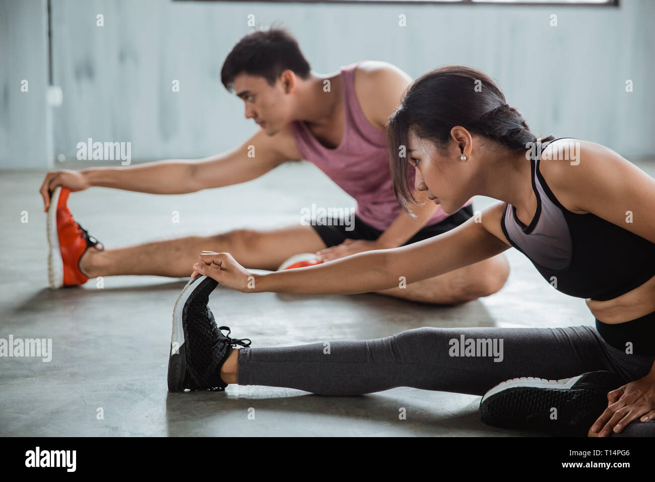 a couple doing stretching together Stock Photo - Alamy