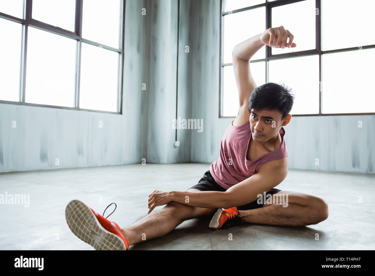 Asian man stretching muscles hi-res stock photography and images - Alamy