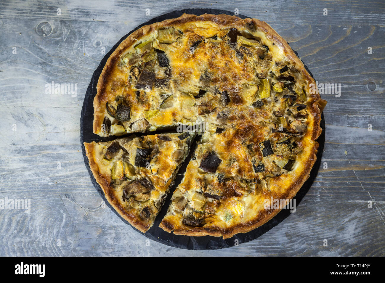 French Vegetable Quiche Lorraine pie with a slice cut, seen from above ...