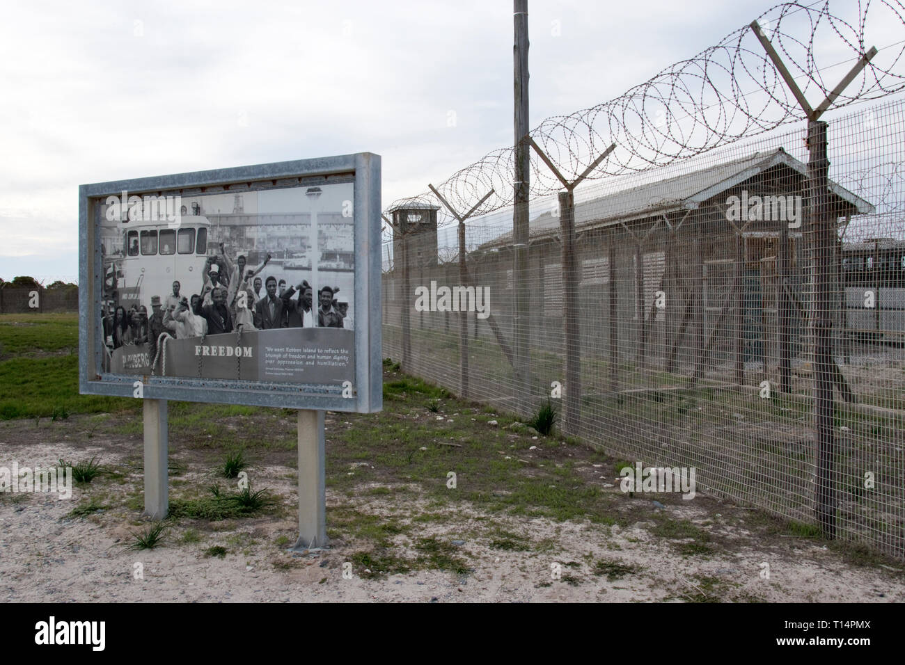 A barbed wire fence and prison block at Robben Island, where Nelson ...