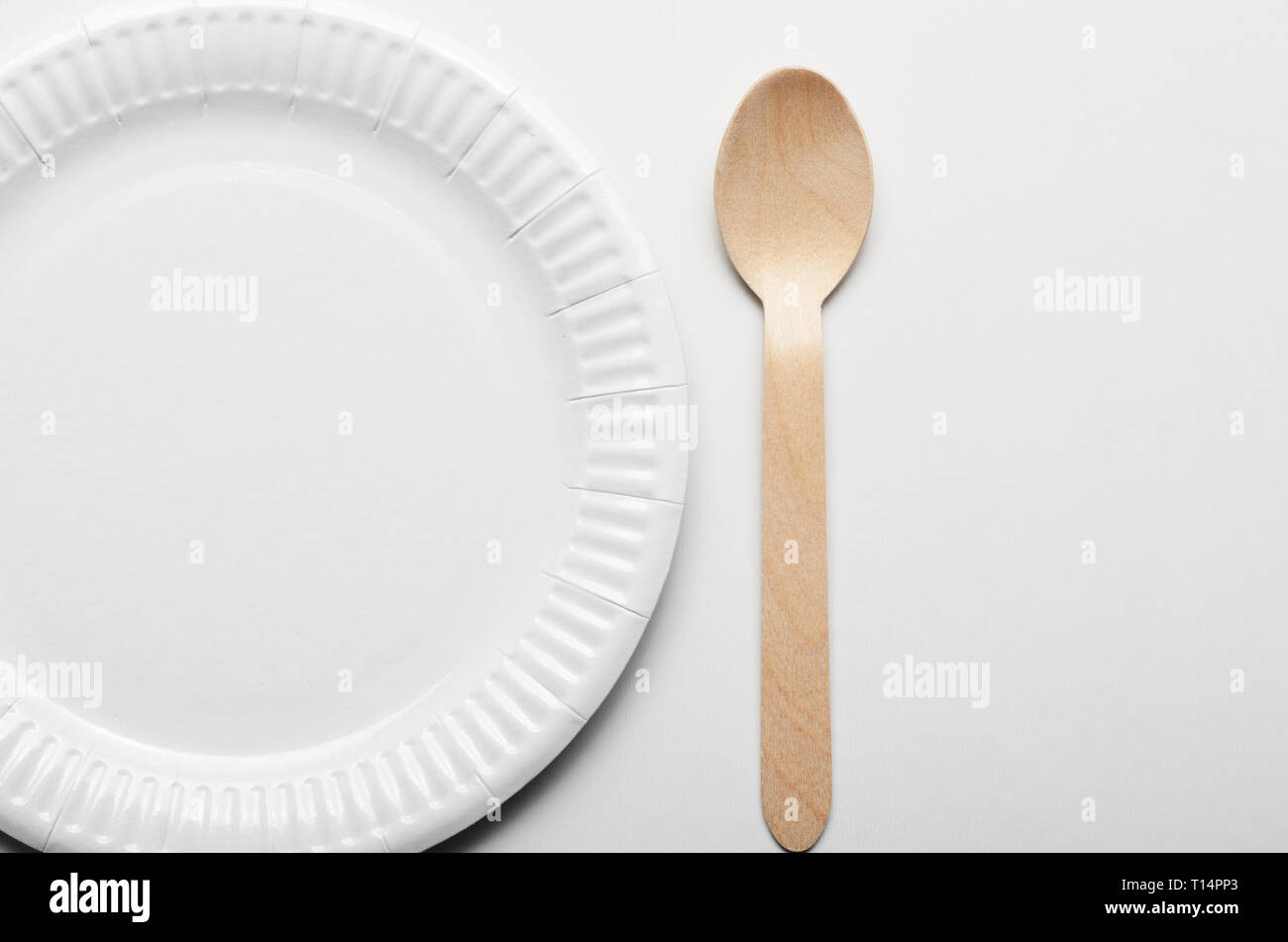 Wooden single use kitchenware and paper plate on white background ...