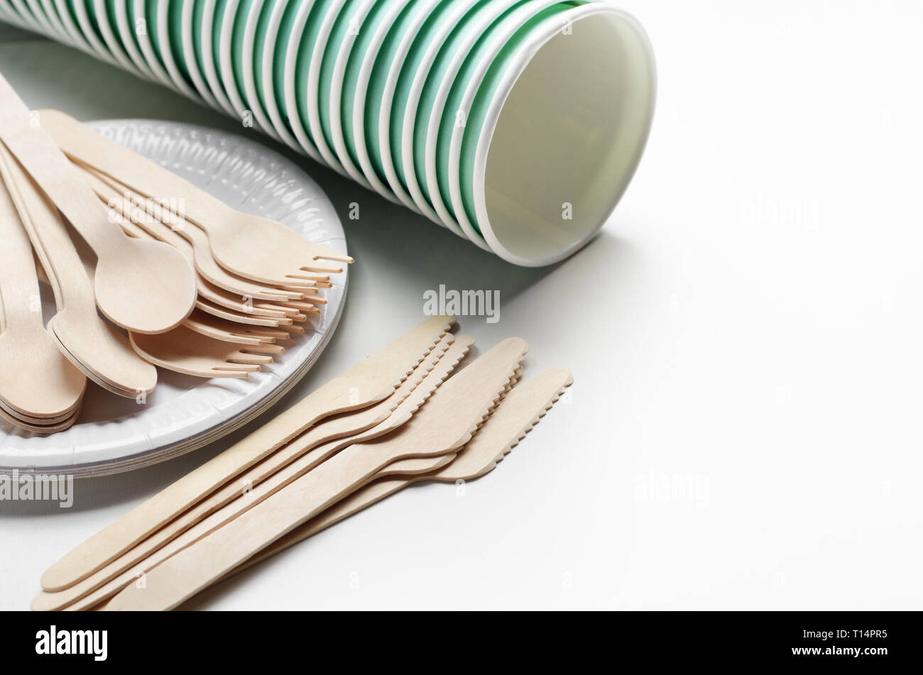 Wooden single use kitchenware and paper cups and plates on white Stock ...