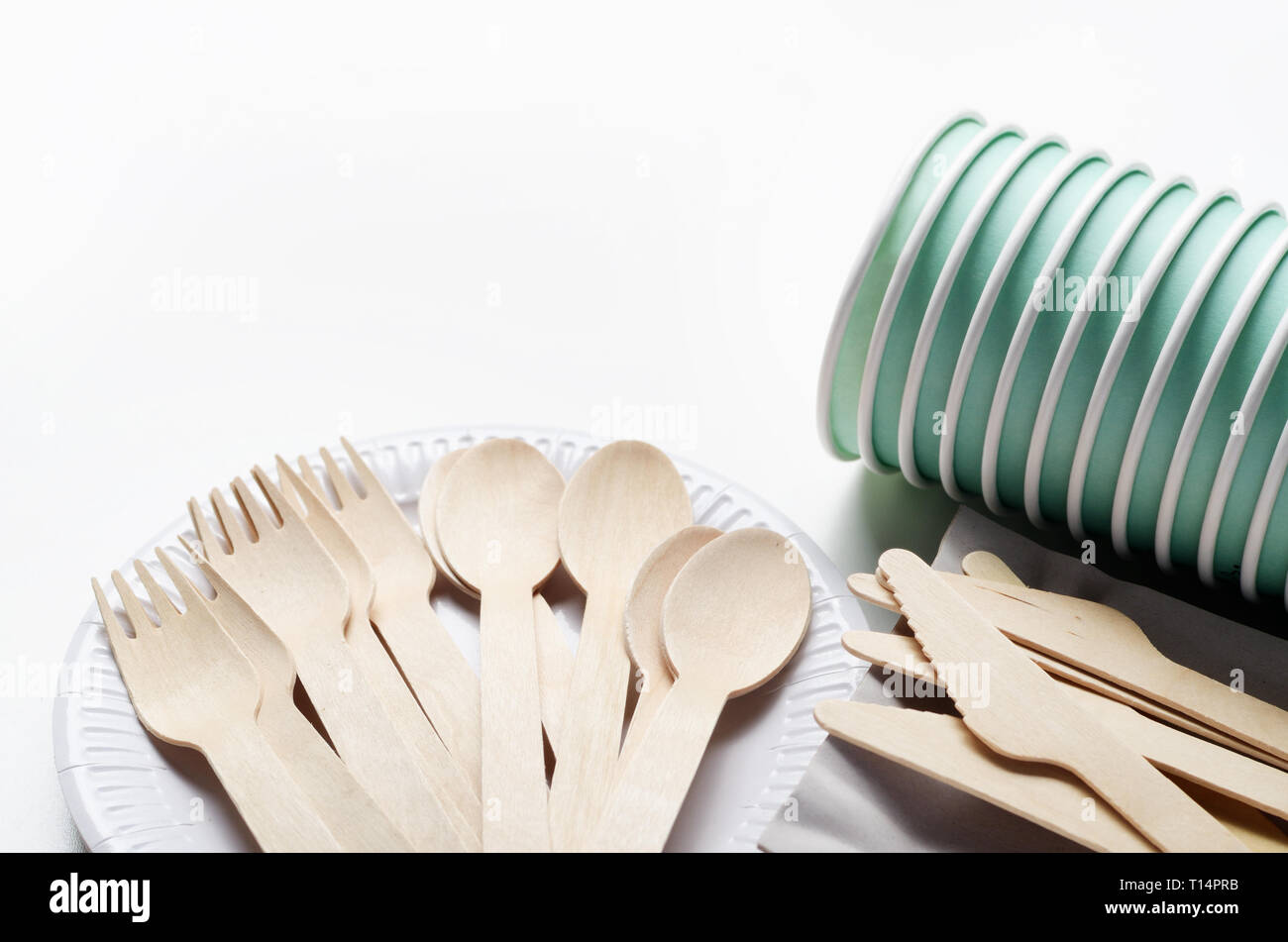 Wooden single use kitchenware and paper cups and plates on white Stock ...