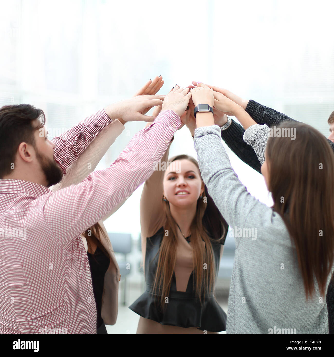 Colleagues showing team work in office interior Stock Photo - Alamy