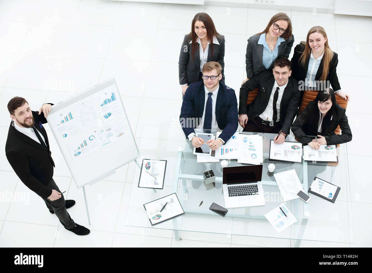 business coach teaching employees on whiteboard at corporate training ...