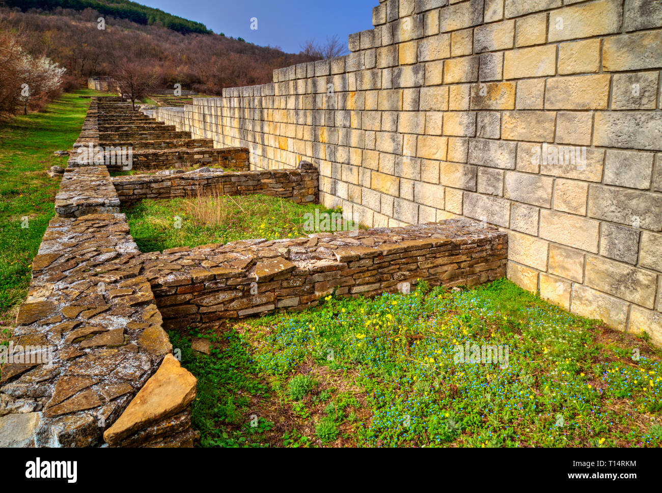 Solid stone wall and ruins of ancient fortress Stock Photo - Alamy