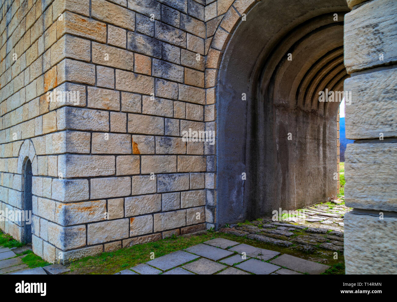 Solid stone wall and entrance of ancient fortress Stock Photo - Alamy
