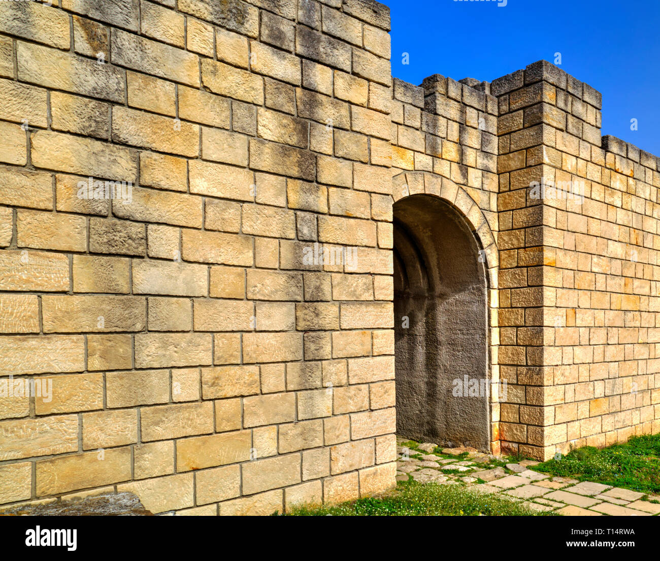 Solid stone wall and entrance of ancient fortress Stock Photo - Alamy