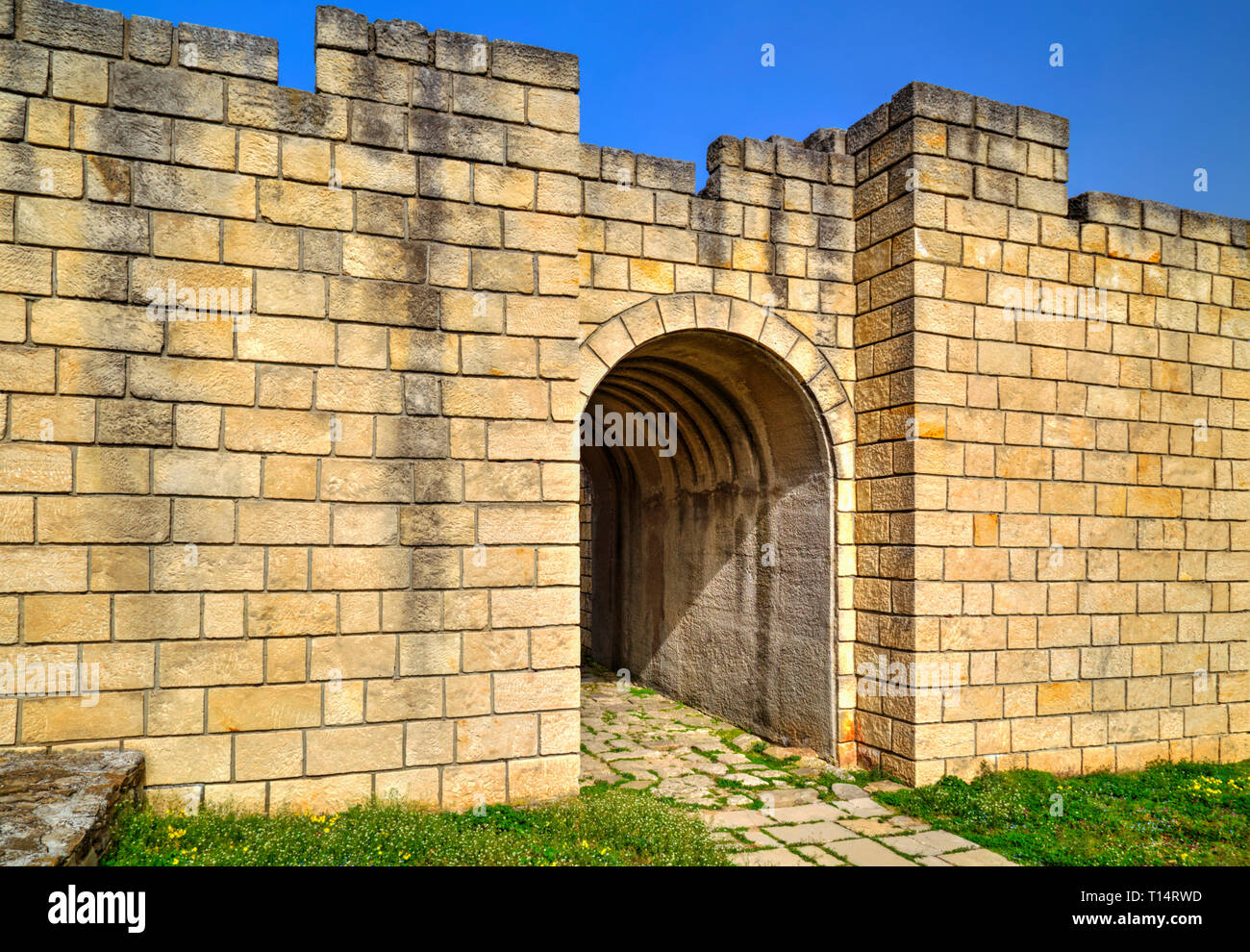 Solid stone wall and entrance of ancient fortress Stock Photo - Alamy