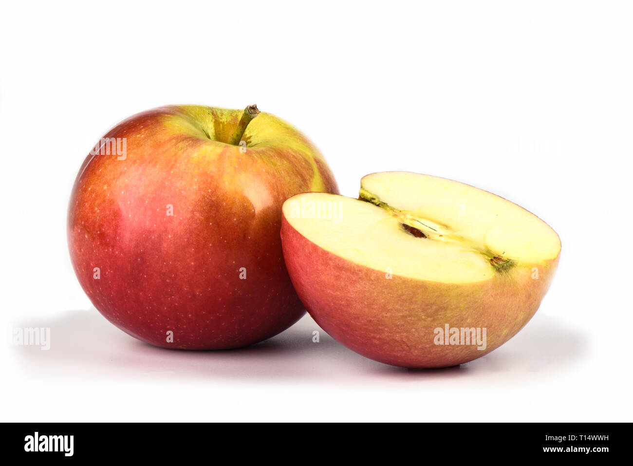 Whole fresh apple and half an apple isolated on white background. Close ...