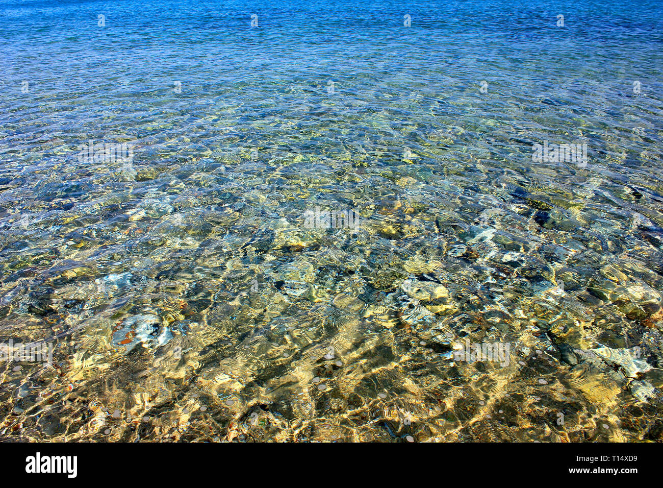 Blue sea flowing water surface with waves and sun glitters Stock Photo ...