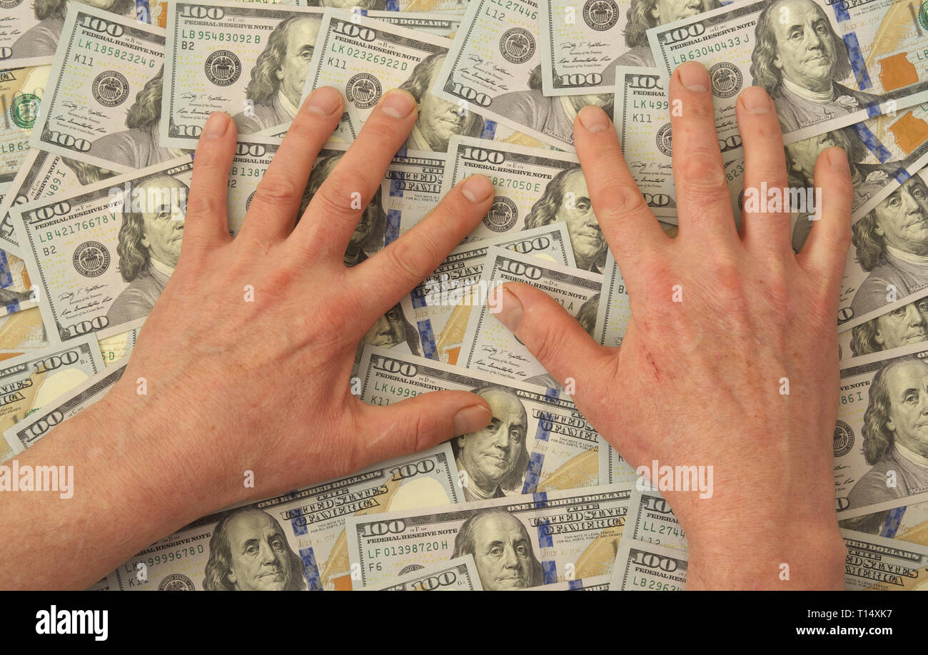 greedy hands cover one hundred dollar bills Stock Photo - Alamy