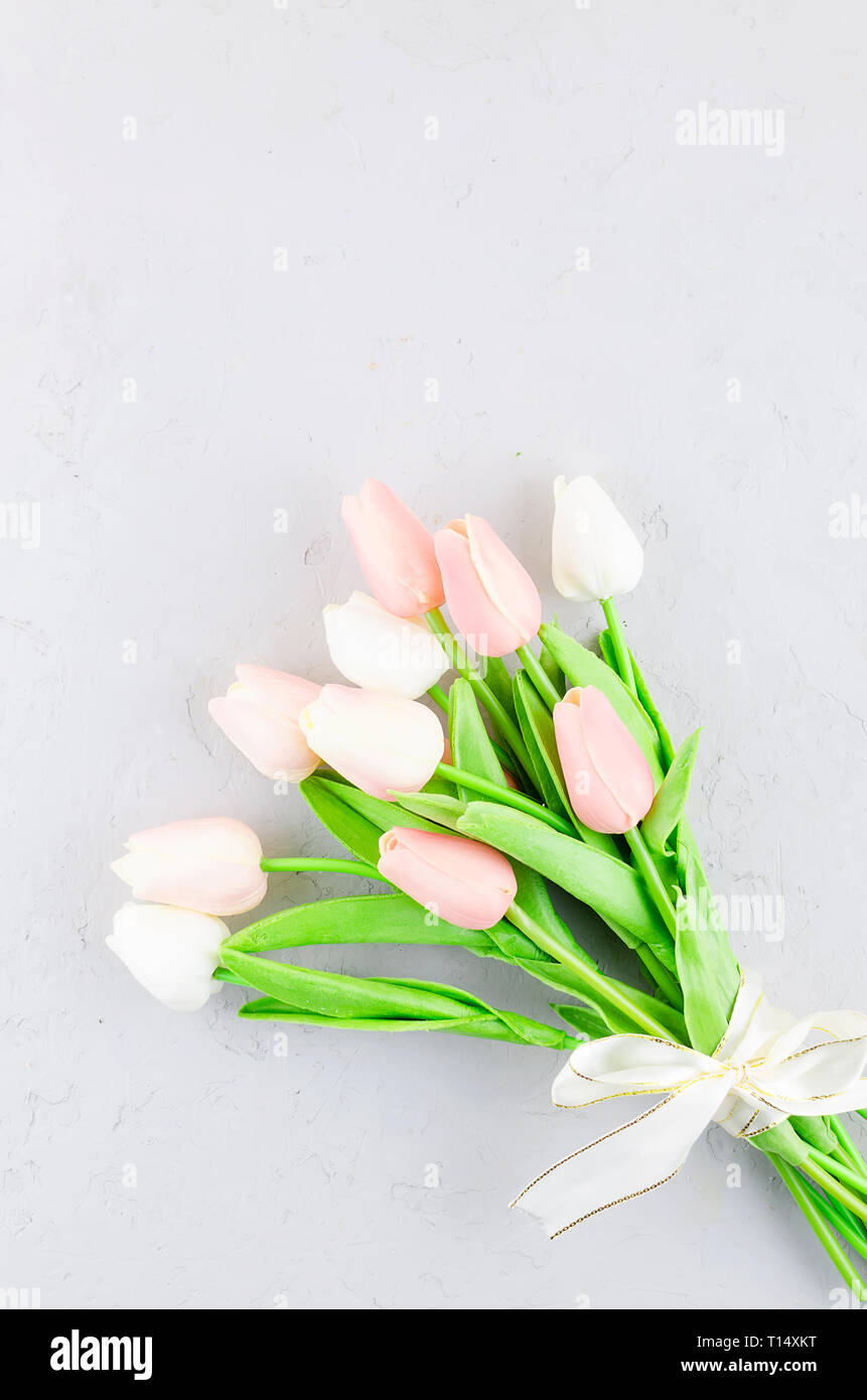 bouquet of light pink tulips on a gray concrete background, concept of ...