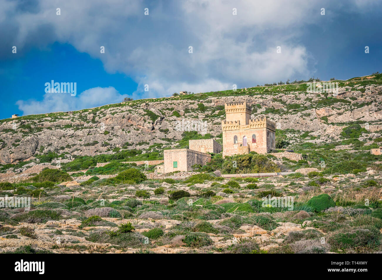 Ghar Lapsi tower on a hilly landscape in Malta. Medieval watchtower ...