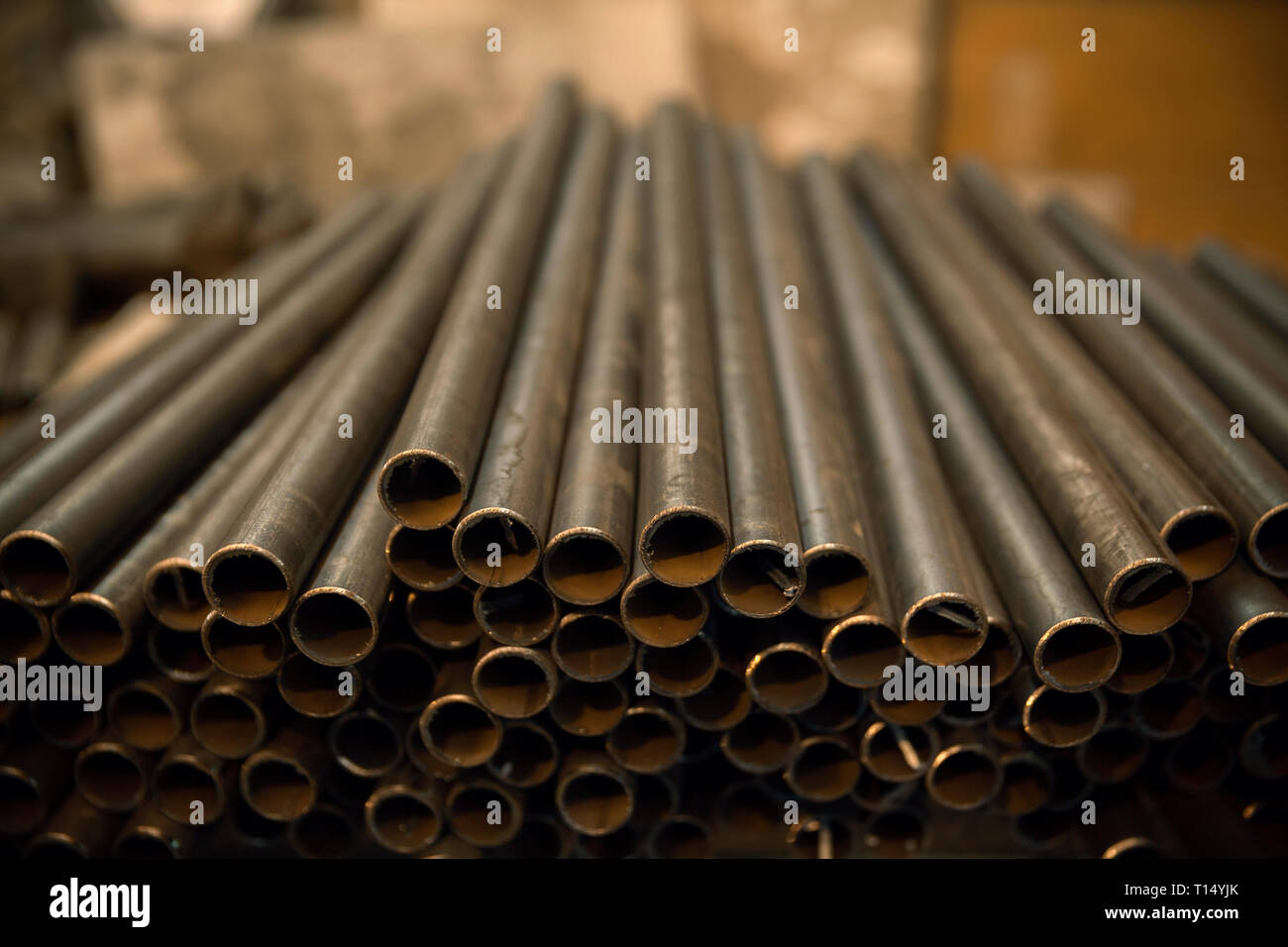 metal pipes stored for work in work shop Stock Photo - Alamy