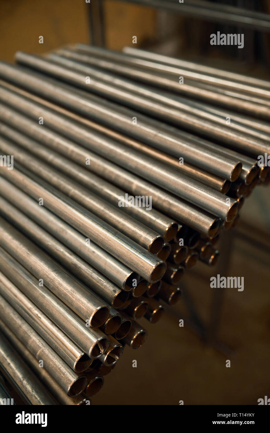 metal pipes stored for work in work shop Stock Photo - Alamy