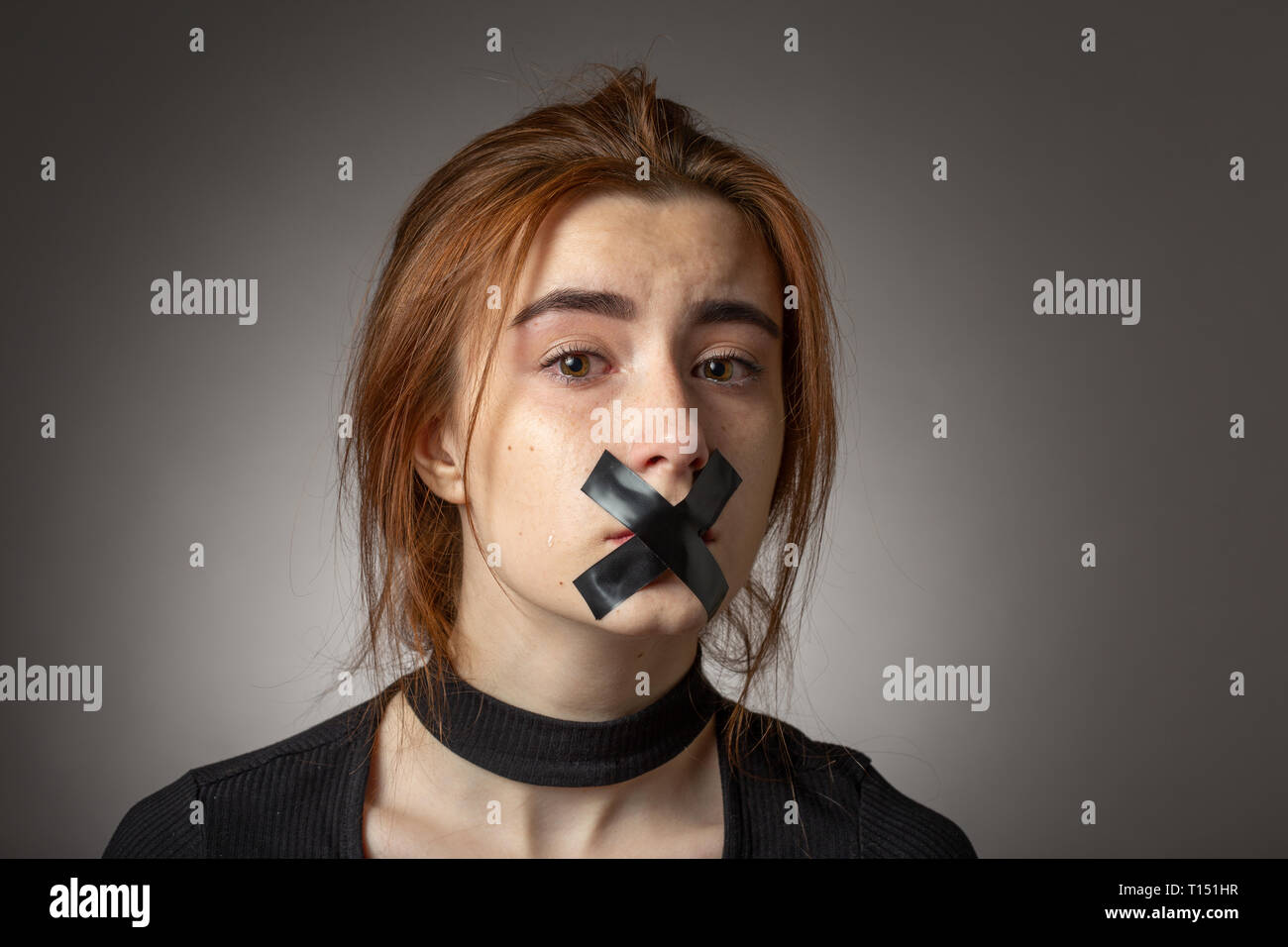 scared crying girl with tape on her mouth looking at camera Stock Photo ...