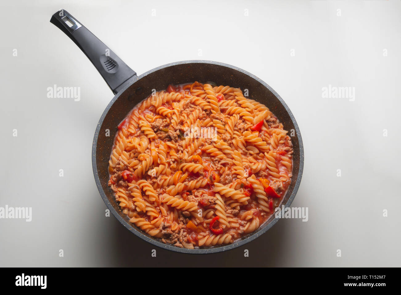 Cooked pasta in a pan white background Stock Photo - Alamy