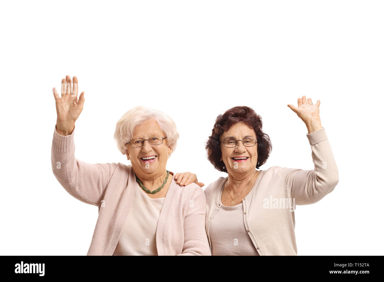 Two cheerful elderly women waving isolated on white background Stock ...