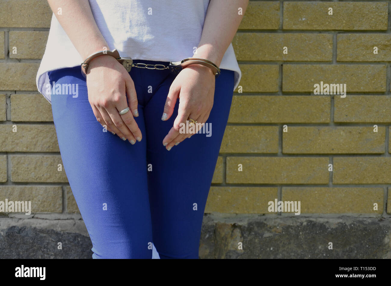 Woman handcuffed to wall hi-res stock photography and images - Alamy