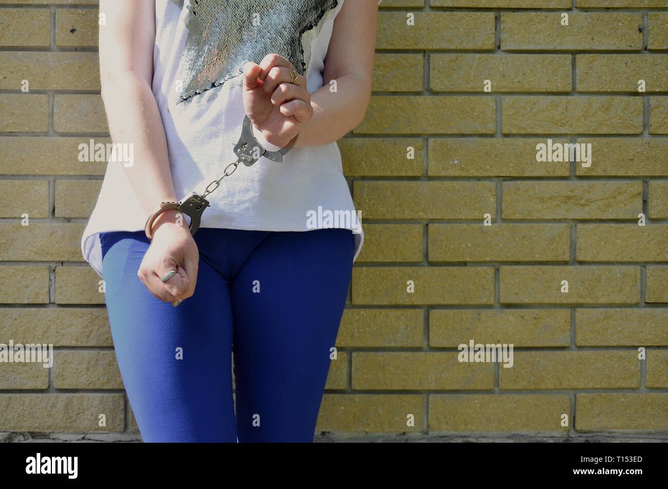 Woman handcuffed to wall hi-res stock photography and images - Alamy