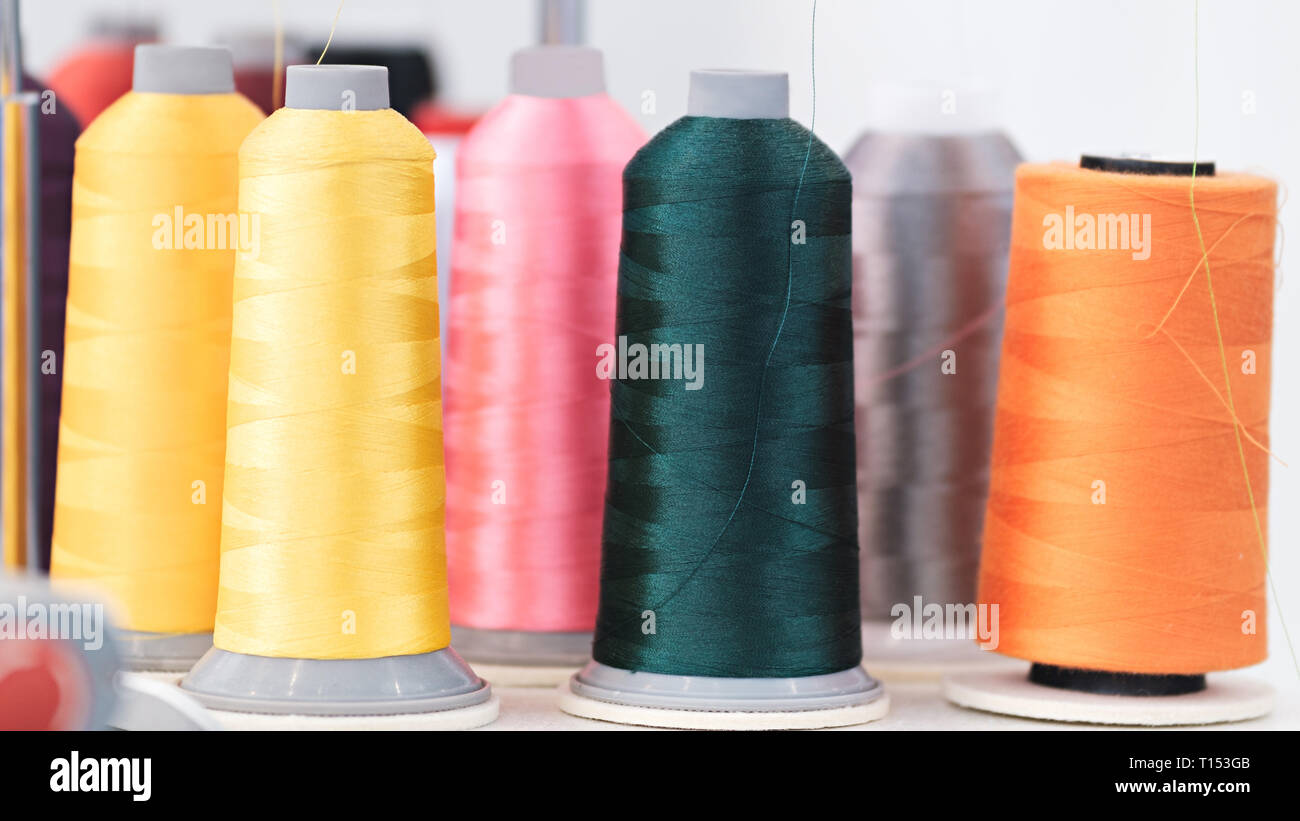 Colorful reels of threads. web banner background Stock Photo - Alamy