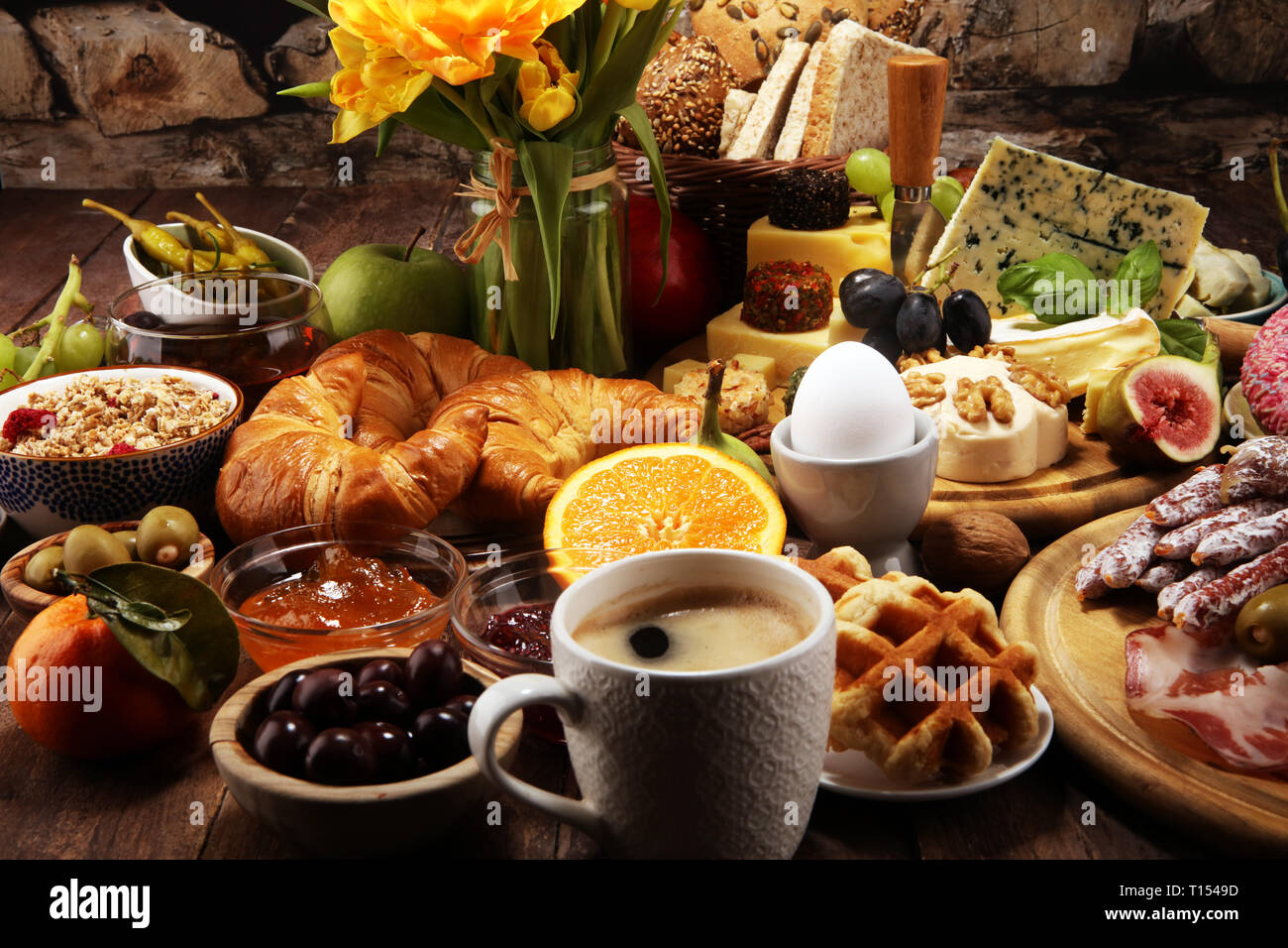 breakfast on table with bread buns, croissants, coffe and donuts Stock ...