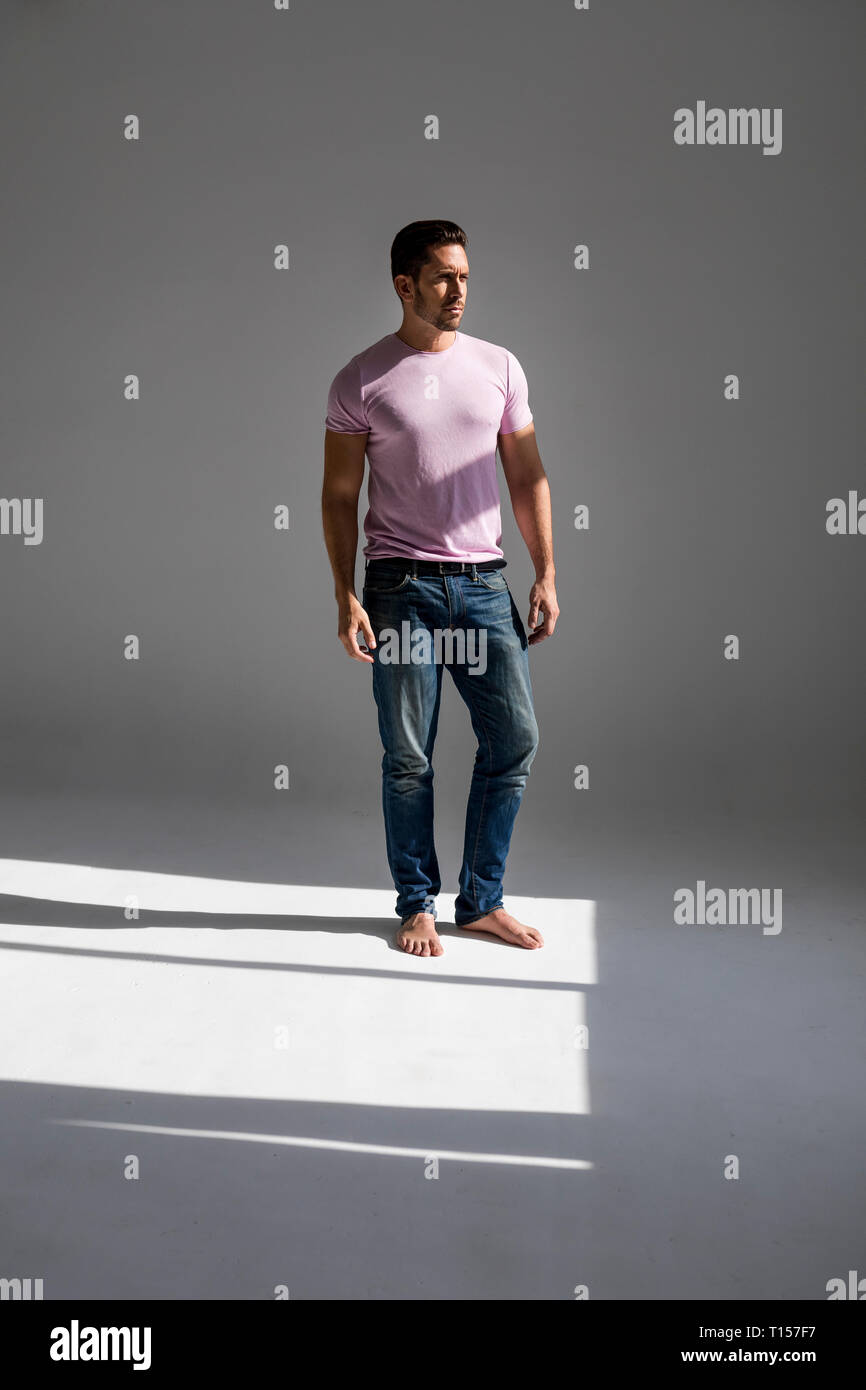 Man standing in a loft in sunshine Stock Photo - Alamy