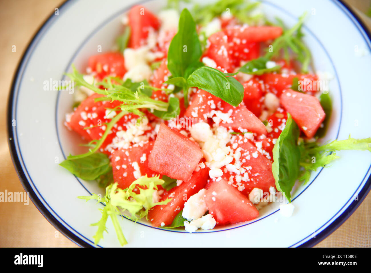 Overhead of cooling melon salad with feta cheese and fresh basil Stock ...