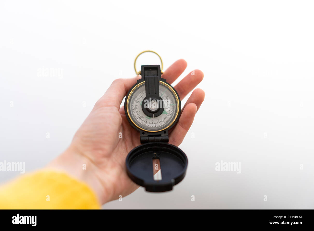 Woman's hand holding compass Stock Photo - Alamy