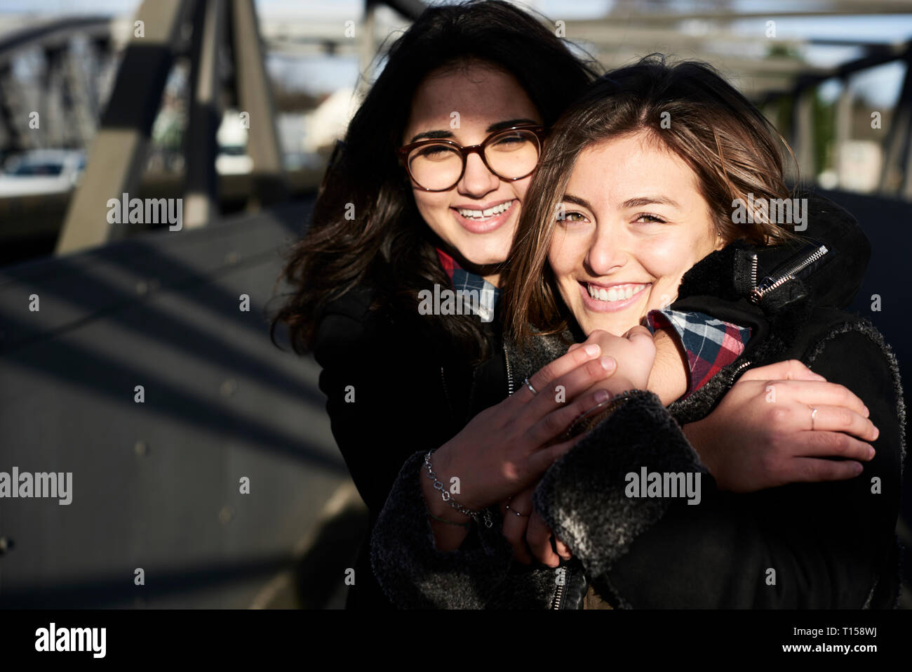 Portrait of happy friends hugging each other Stock Photo - Alamy