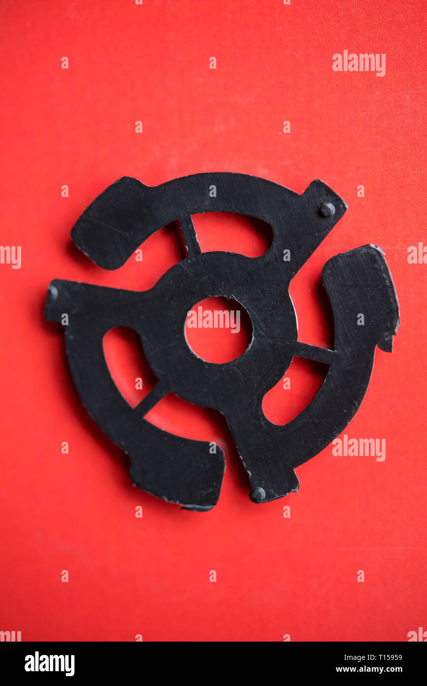 Detail of a plastic center adapter used in the middle of a vinyl record ...