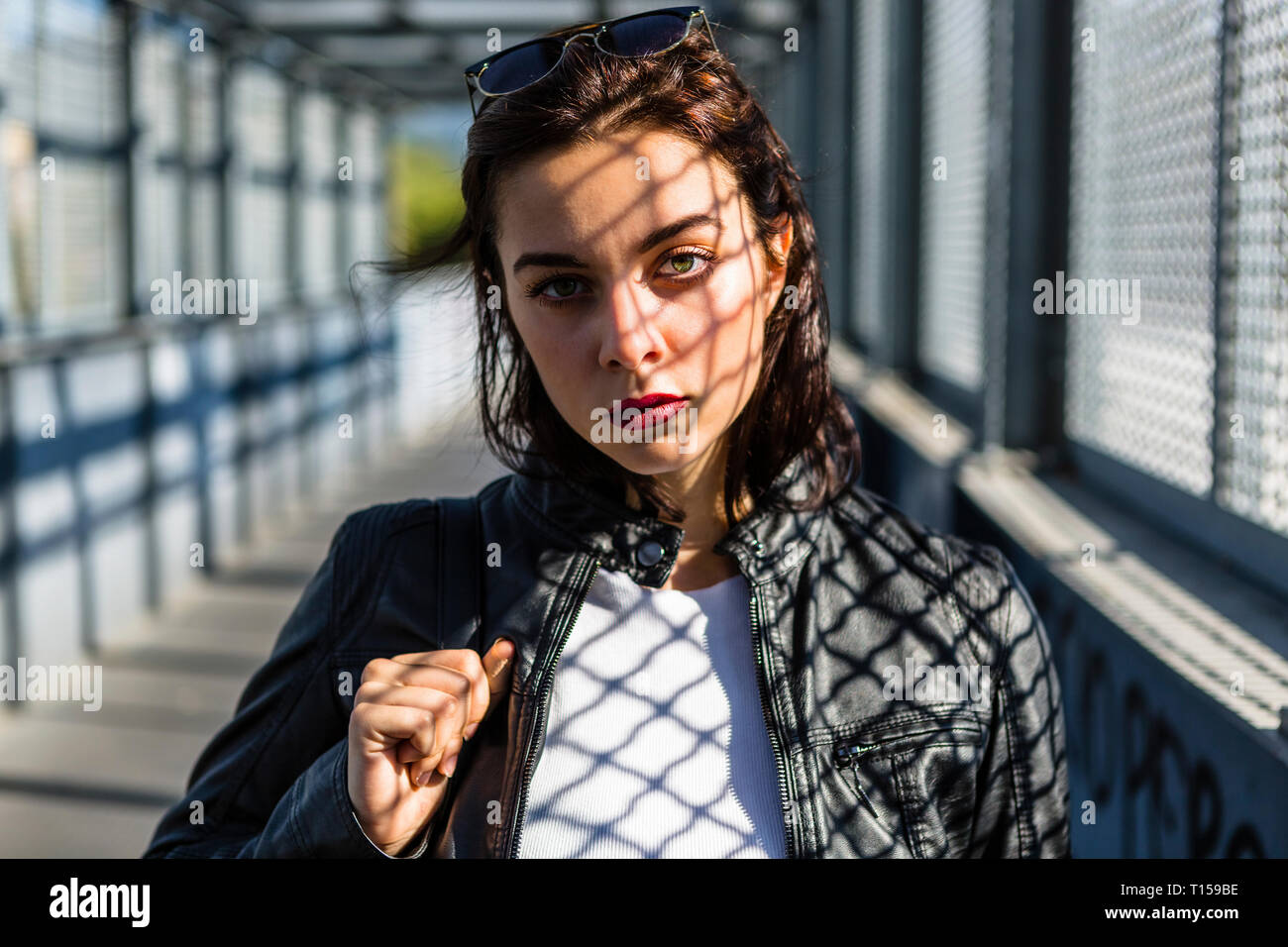 Portrait of young woman on a bridge Stock Photo - Alamy