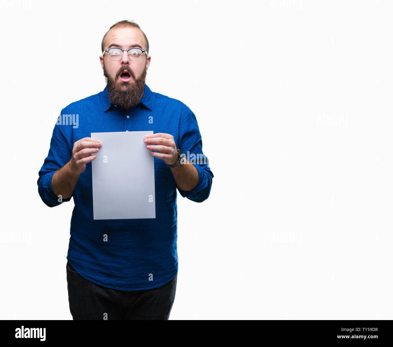 Young hipster man wearing glasses and holding blank paper over isolated ...