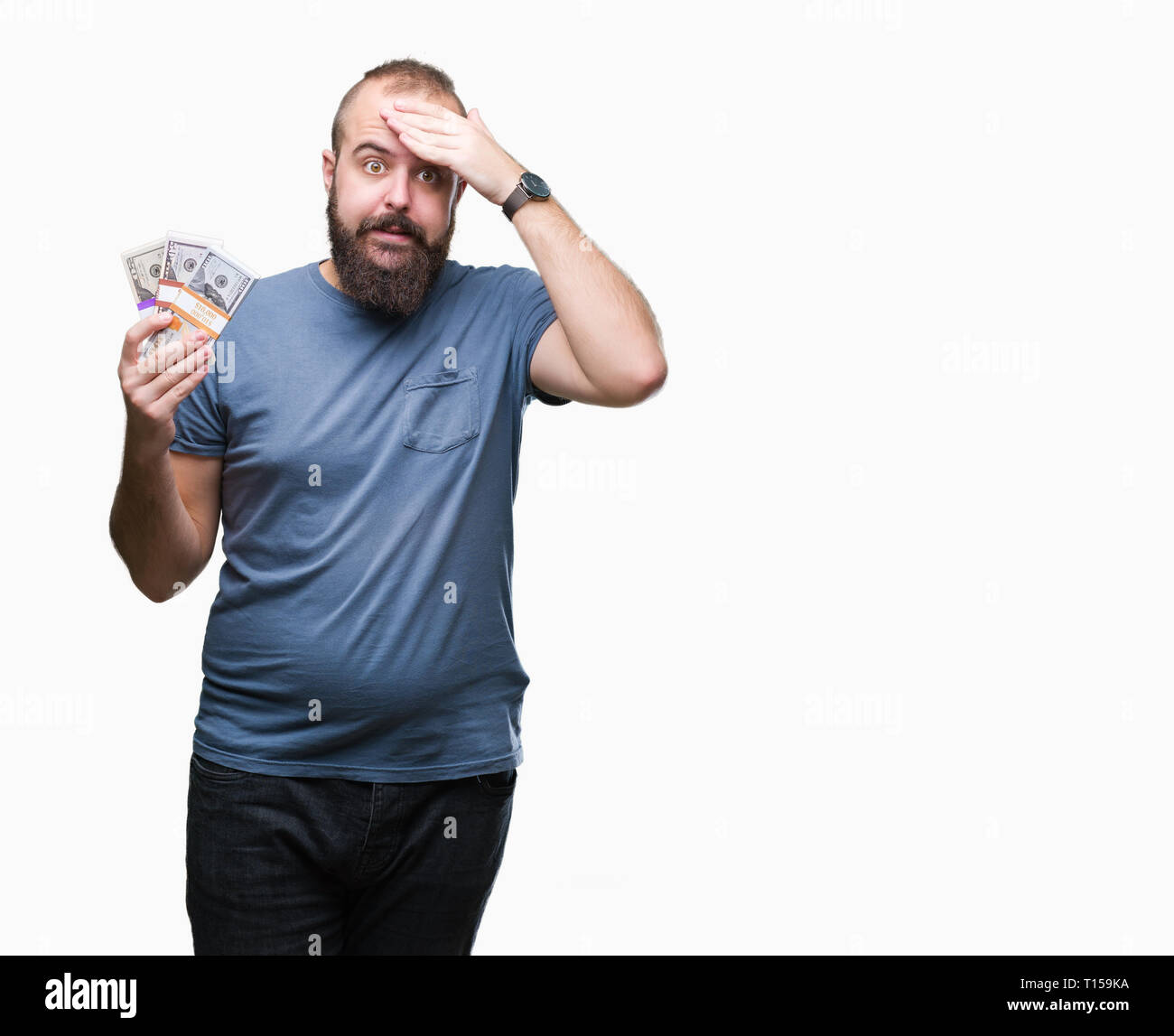 Young hipster man holding bunch of money over isolated background ...