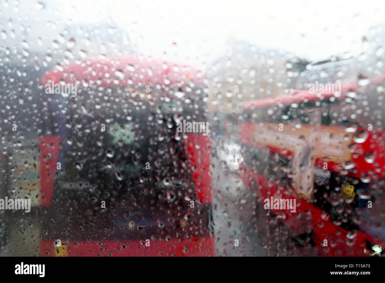 A view of double decker red buses in traffic view from top of bus ...