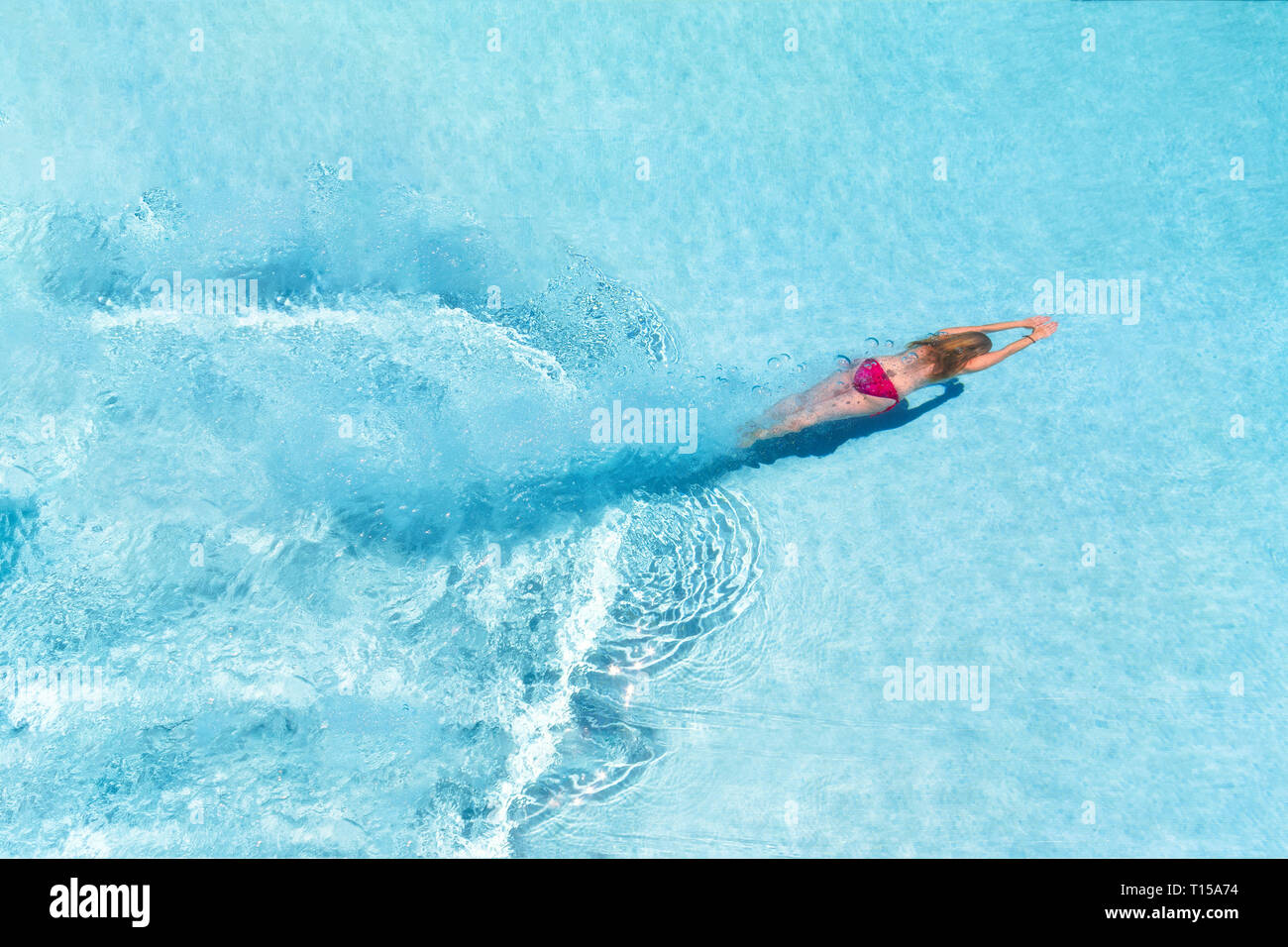 Woman diving into swimming pool hi-res stock photography and images - Alamy