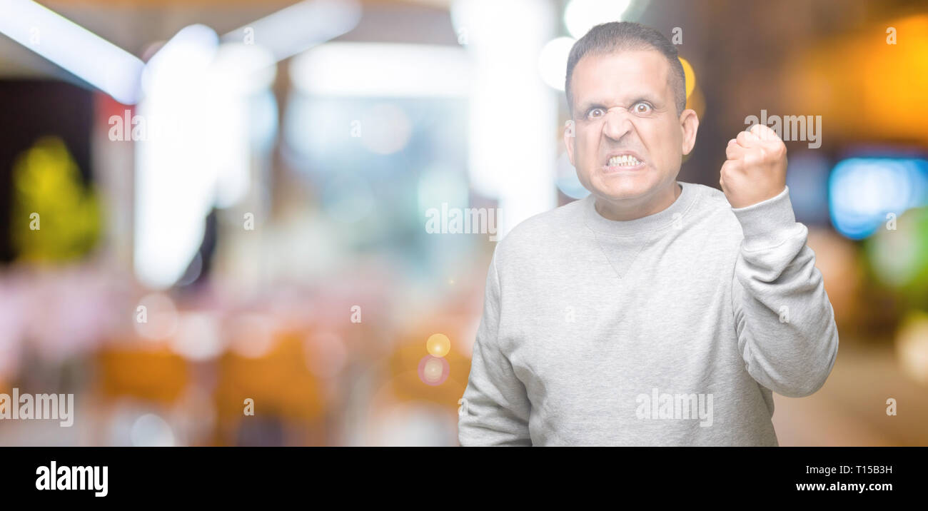 Middle age arab man wearing sport sweatshirt over isolated background ...