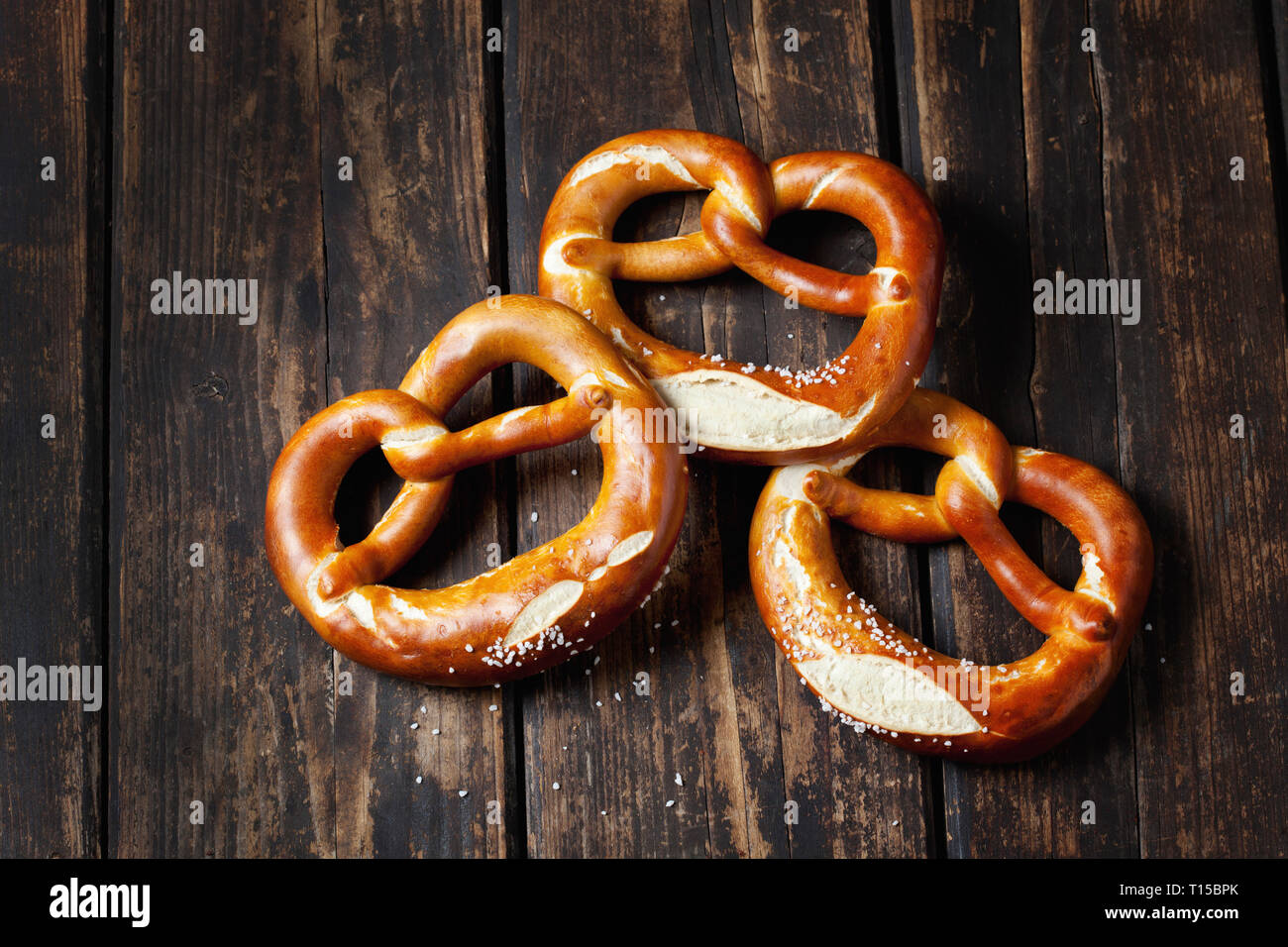 Three pretzels on wood Stock Photo - Alamy
