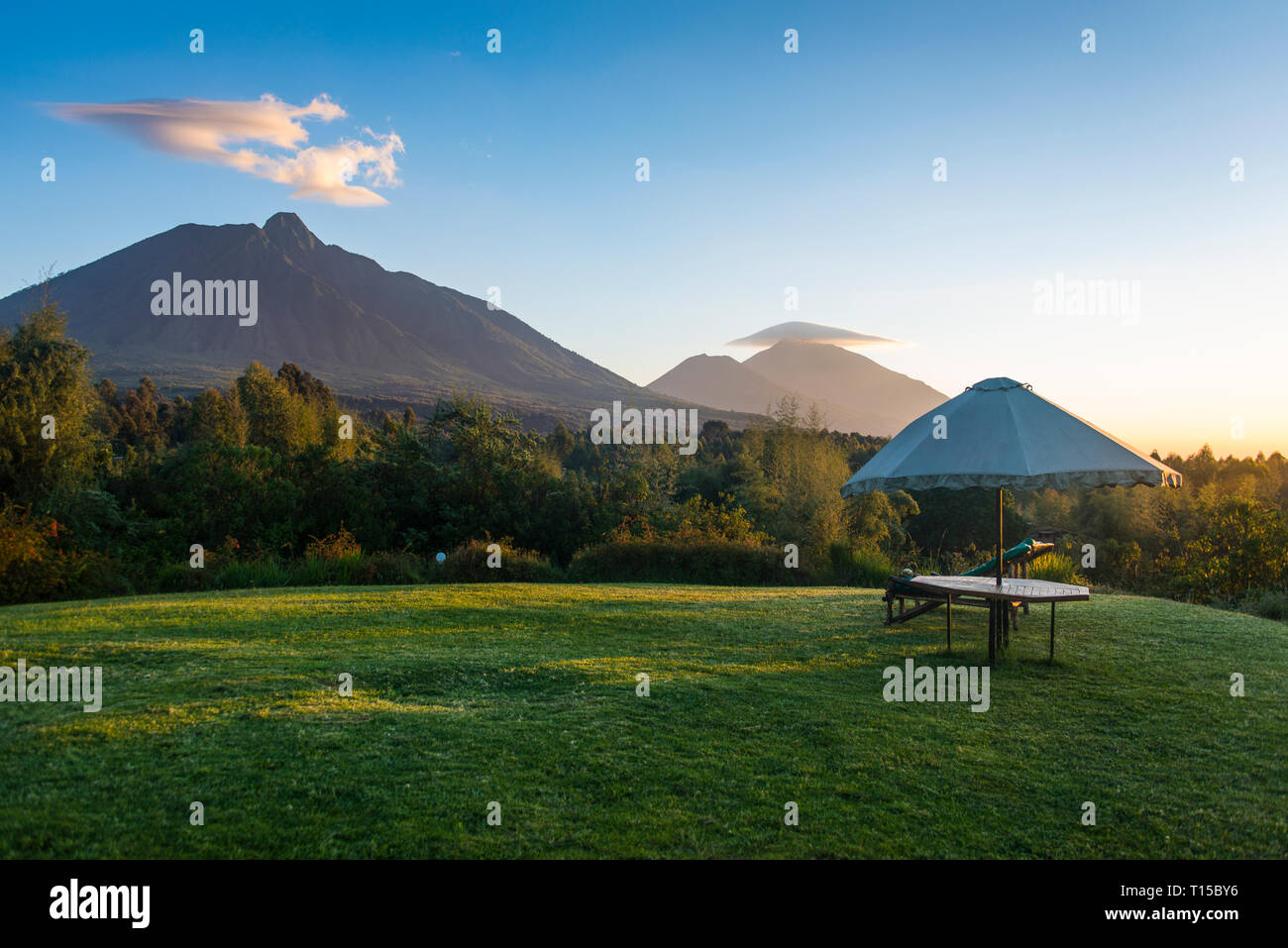 Rwanda, Virunga National Park, sun shade and loungers in garden of ...