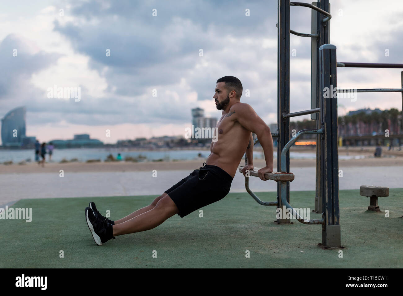 Barechested muscular man doing workout outdoors Stock Photo - Alamy