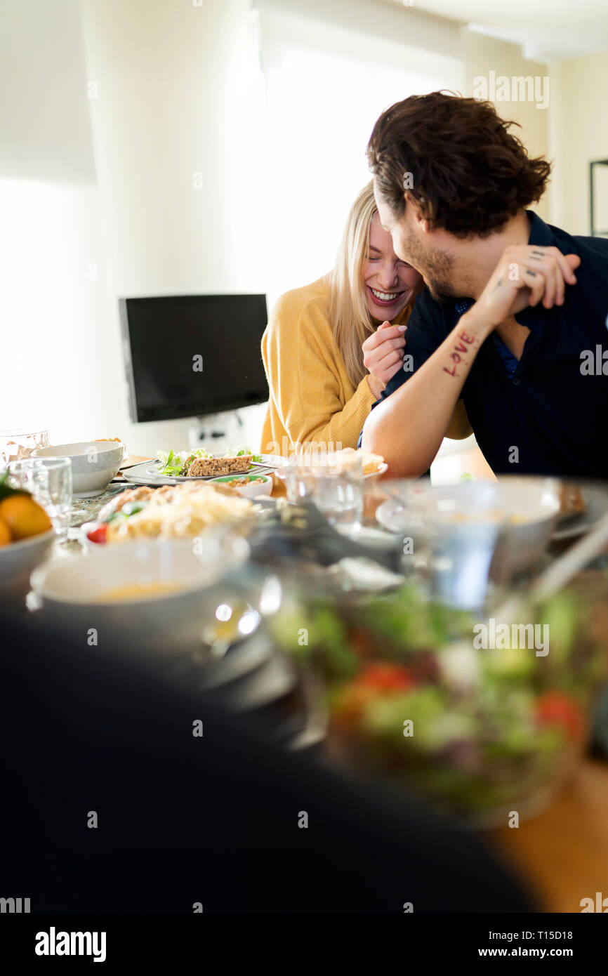 Couple kissing at table hi-res stock photography and images - Alamy