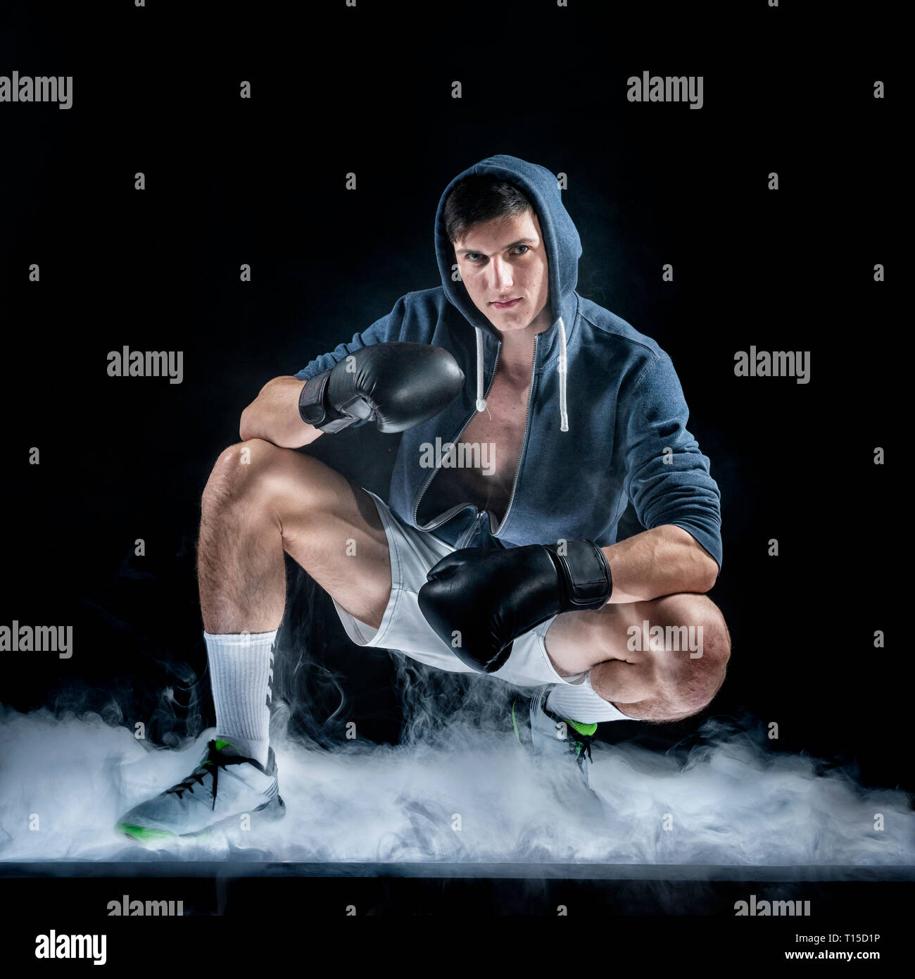 Young boxer against black background with fog Stock Photo - Alamy