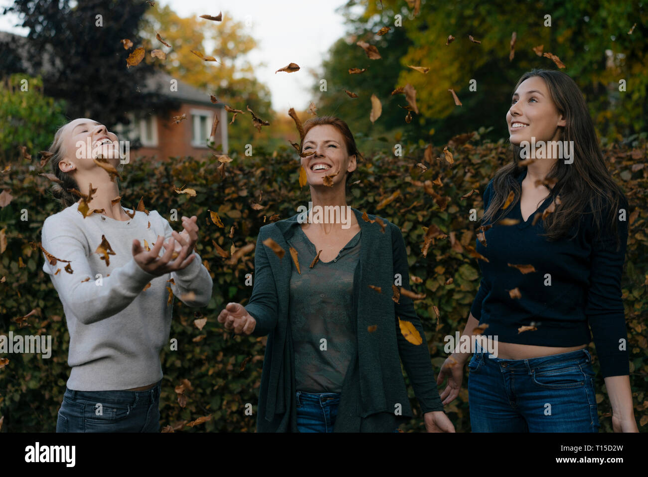 Two girls throwing leaves hi-res stock photography and images - Alamy