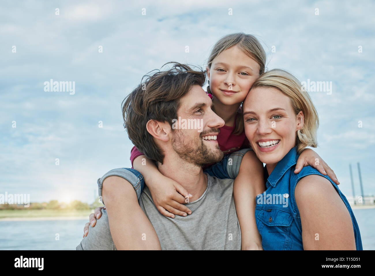 Germany, Duesseldorf, happy family with daughter at Rhine riverbank ...
