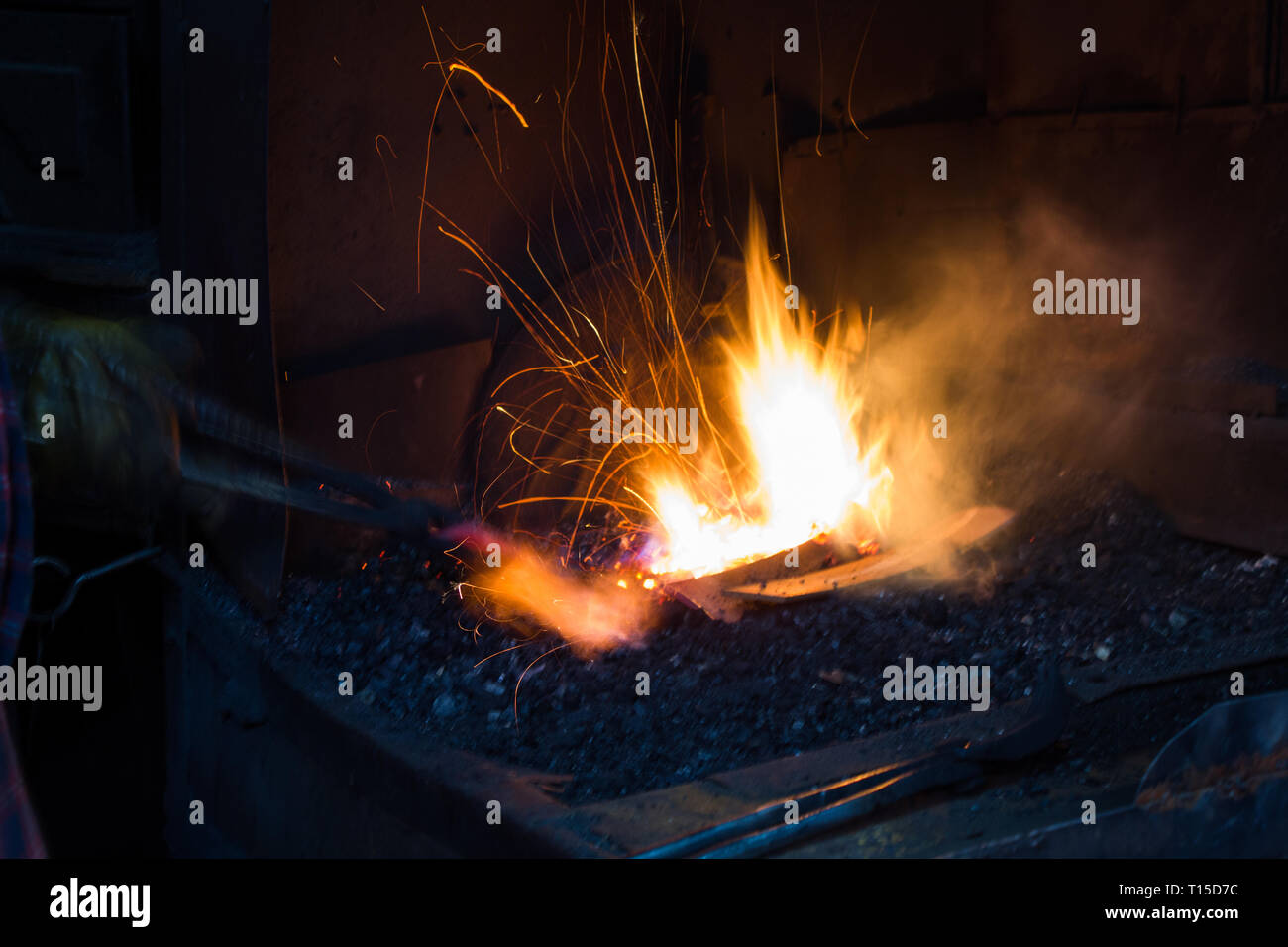 Blacksmith forging iron in workshop Stock Photo - Alamy