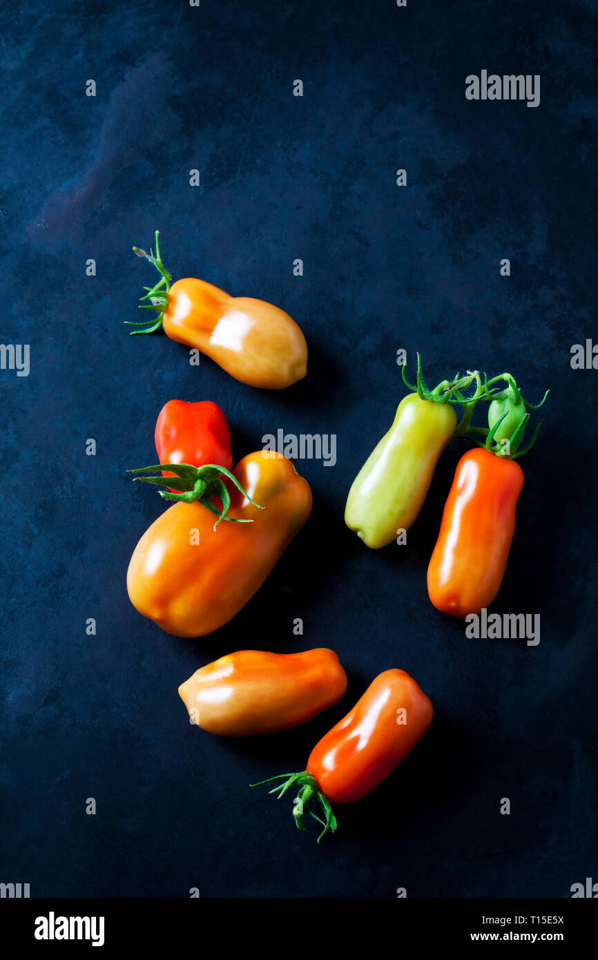 Seven San Marzano tomatoes on dark ground Stock Photo - Alamy