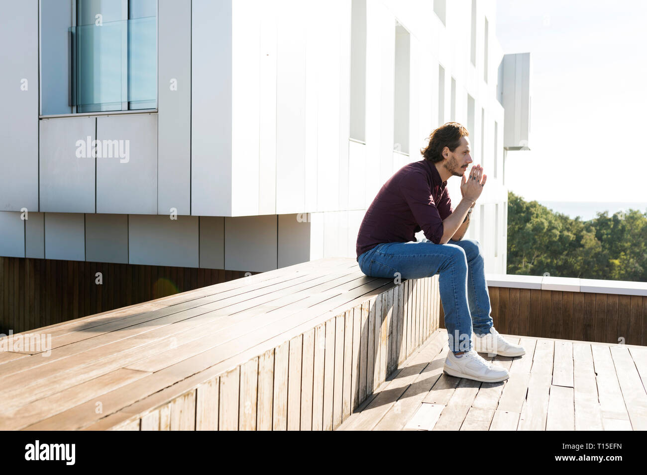 Man sitting rooftop terrace hi-res stock photography and images - Alamy