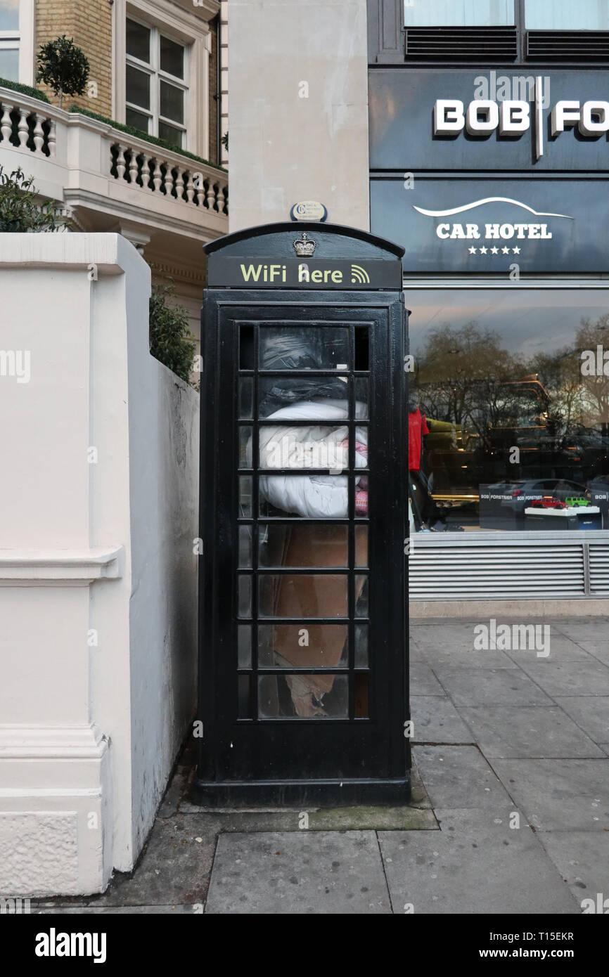 Telephone box stuffed full of homeless persons belongings on Park Lane ...