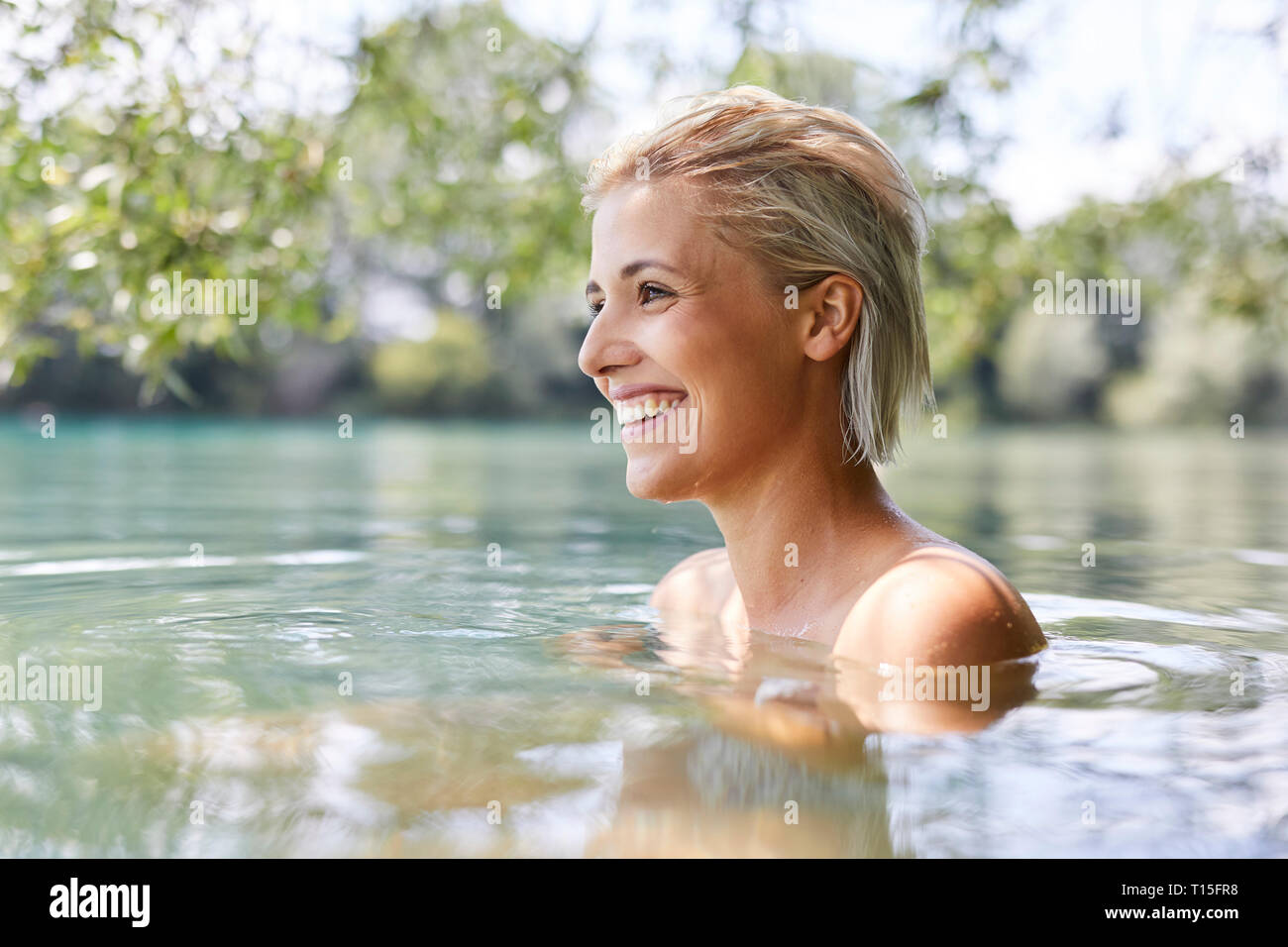 Beautiful woman bathing in a lake Stock Photo - Alamy